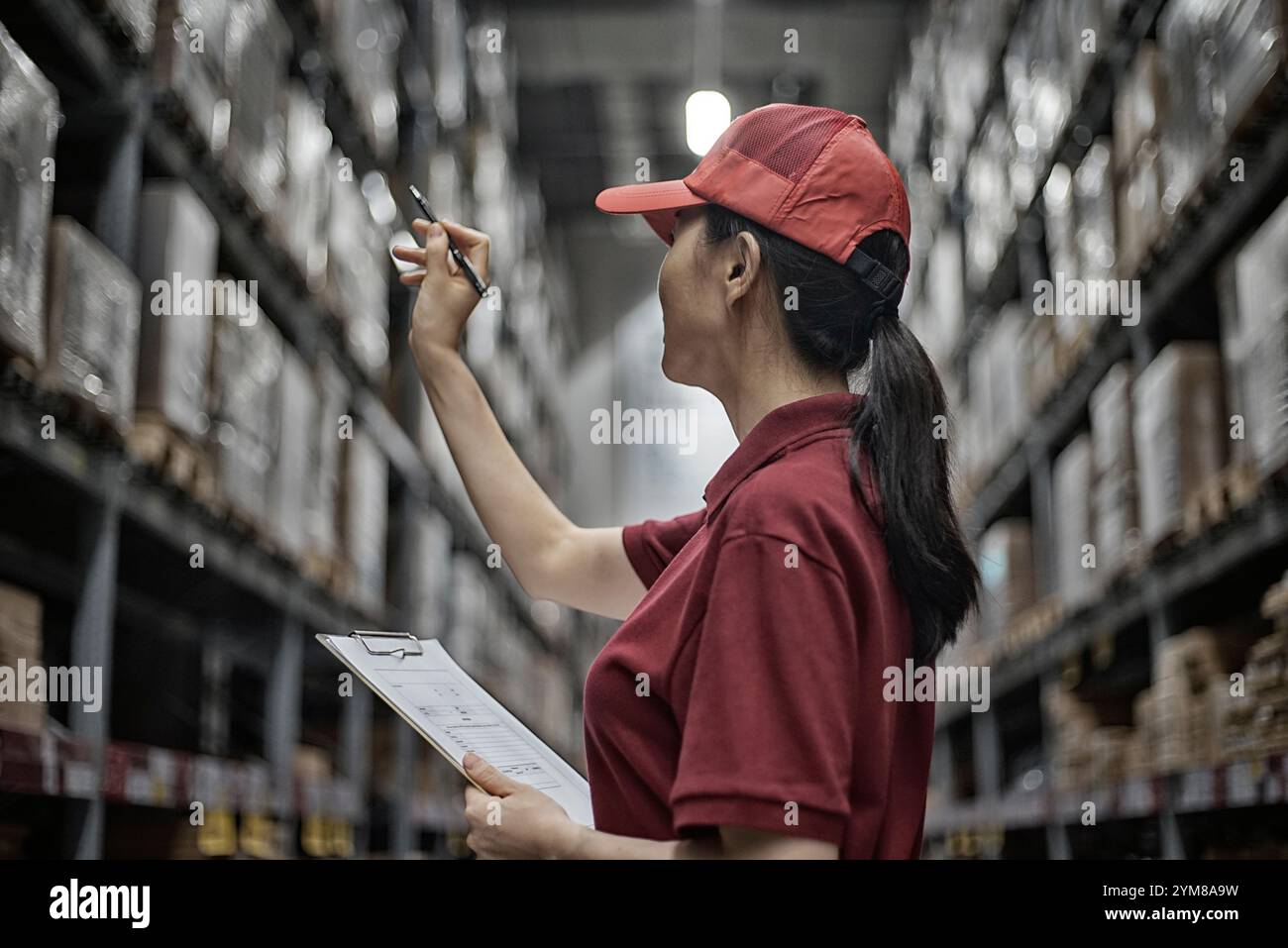 Image of woman checking merchandise Stock Photo - Alamy