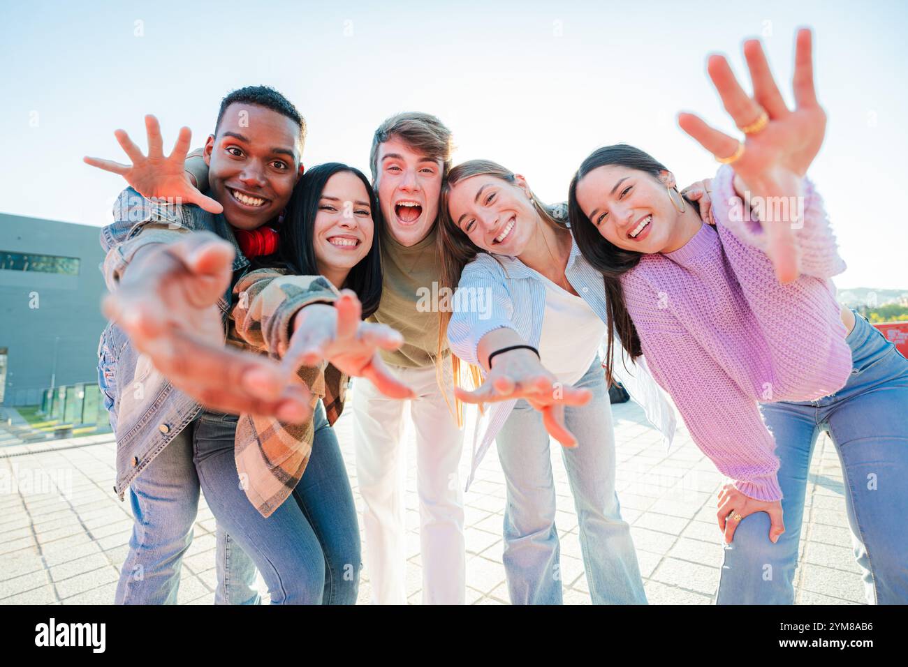 Excited group diverse teenagers joyfully hi-res stock photography and ...
