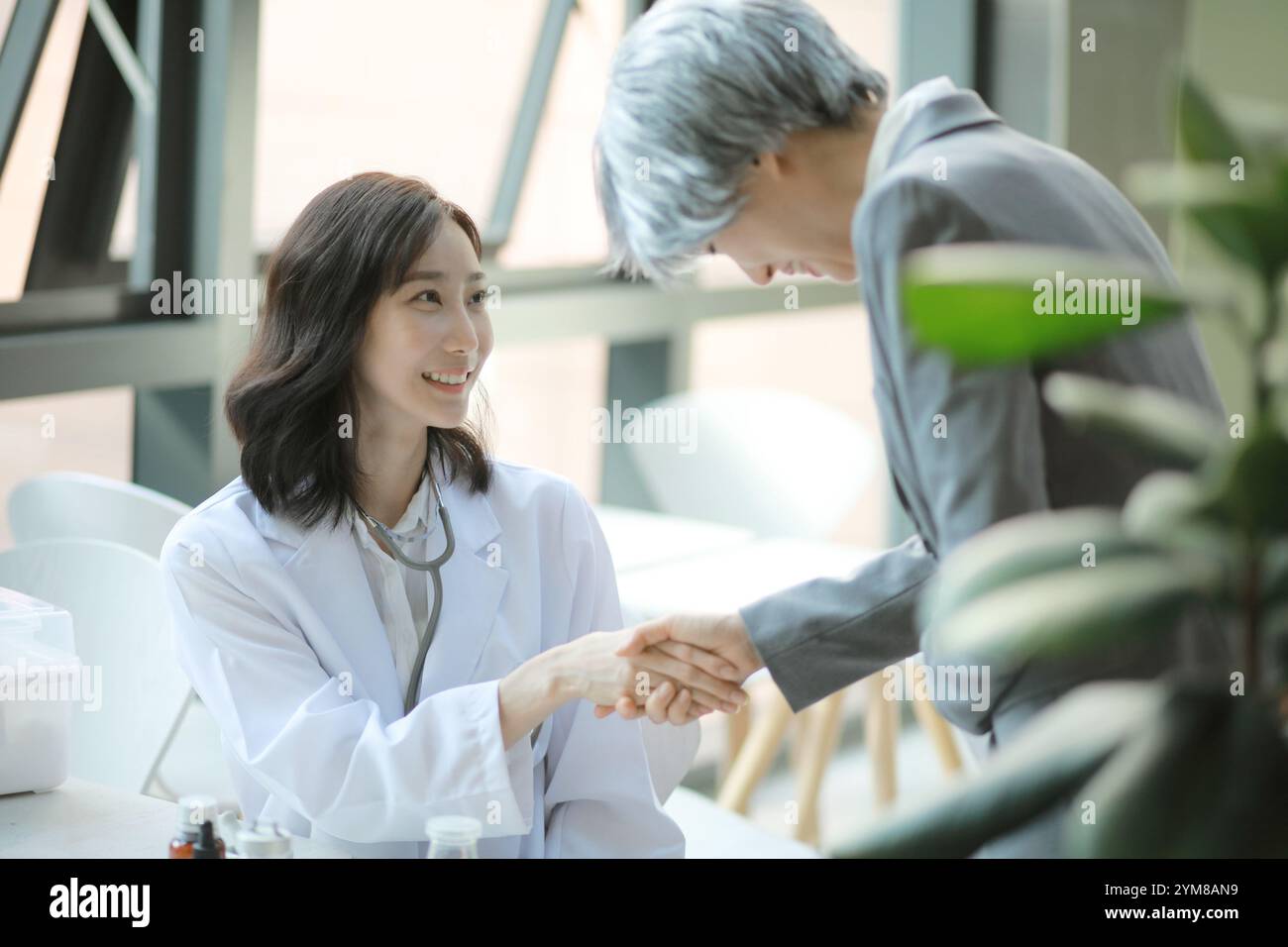 Doctor woman shaking hands in hi-res stock photography and images - Alamy