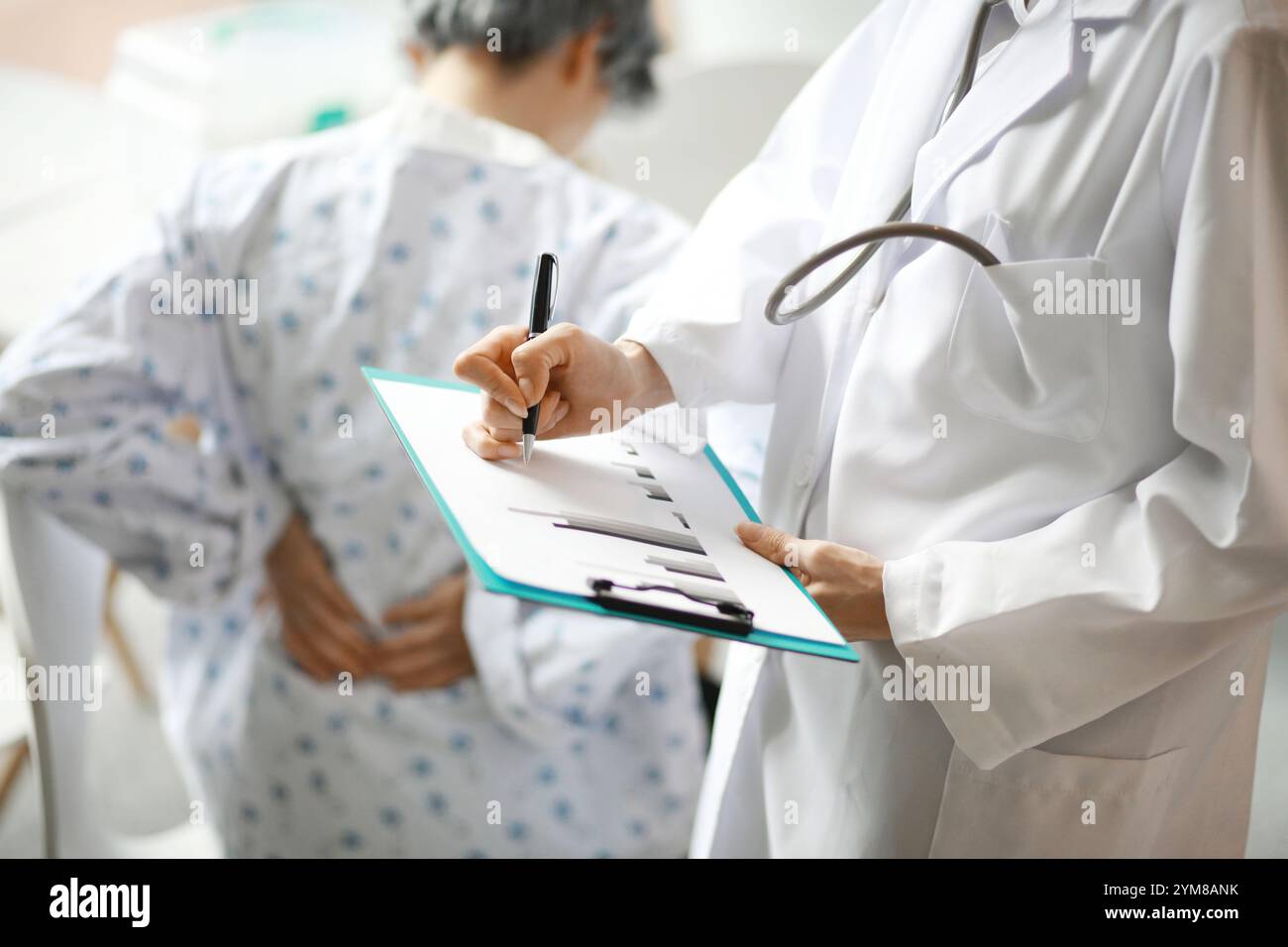Female doctor checking patient's condition on medical chart Stock Photo ...
