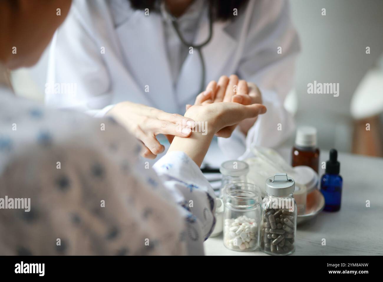 Female doctor taking pulse at hospital Stock Photo - Alamy
