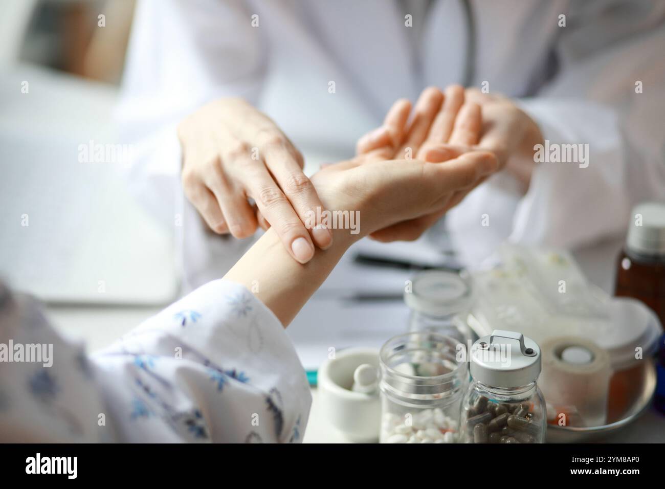 Female doctor taking pulse Stock Photo - Alamy