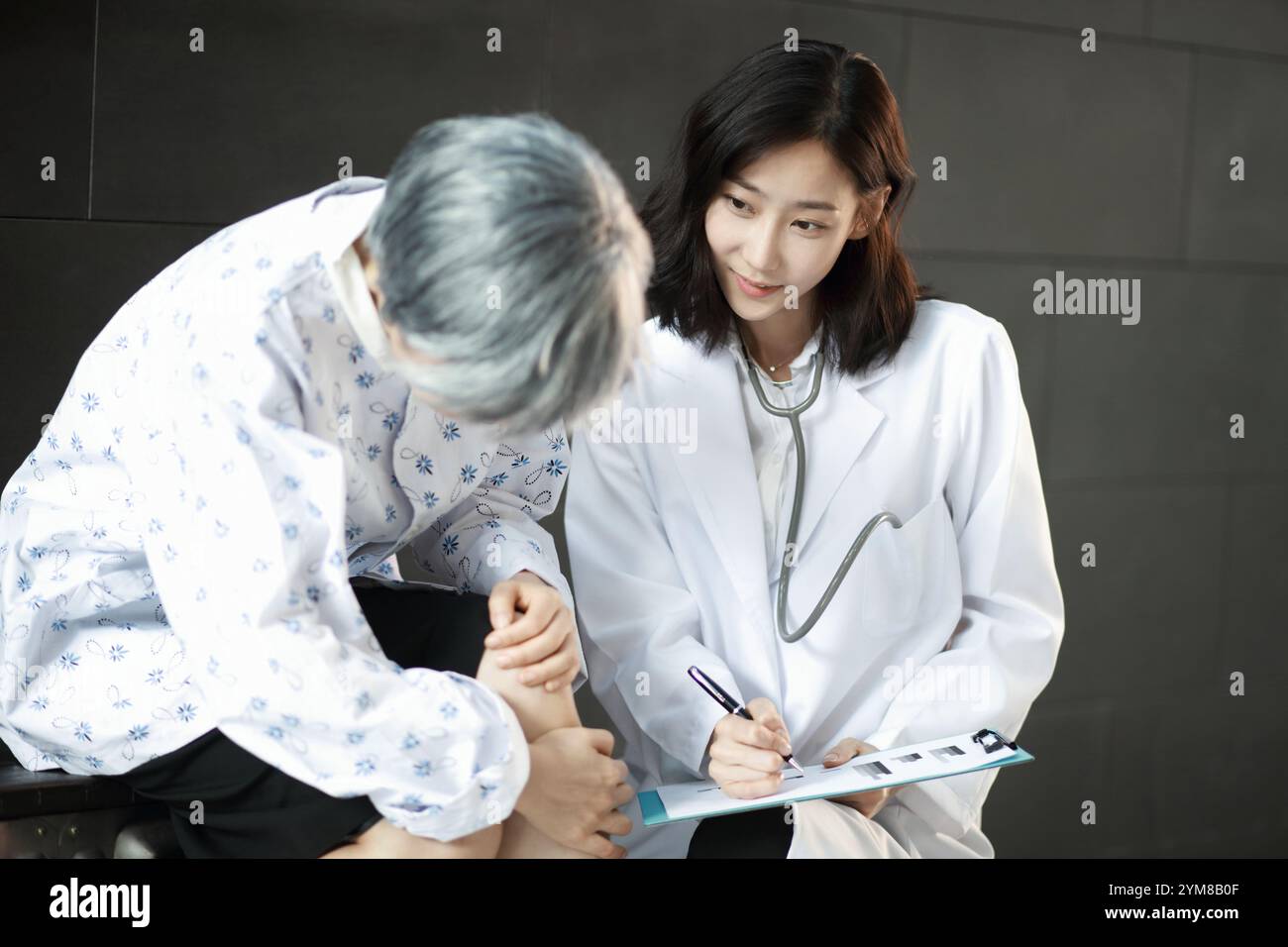 Doctor treating a patient Stock Photo - Alamy