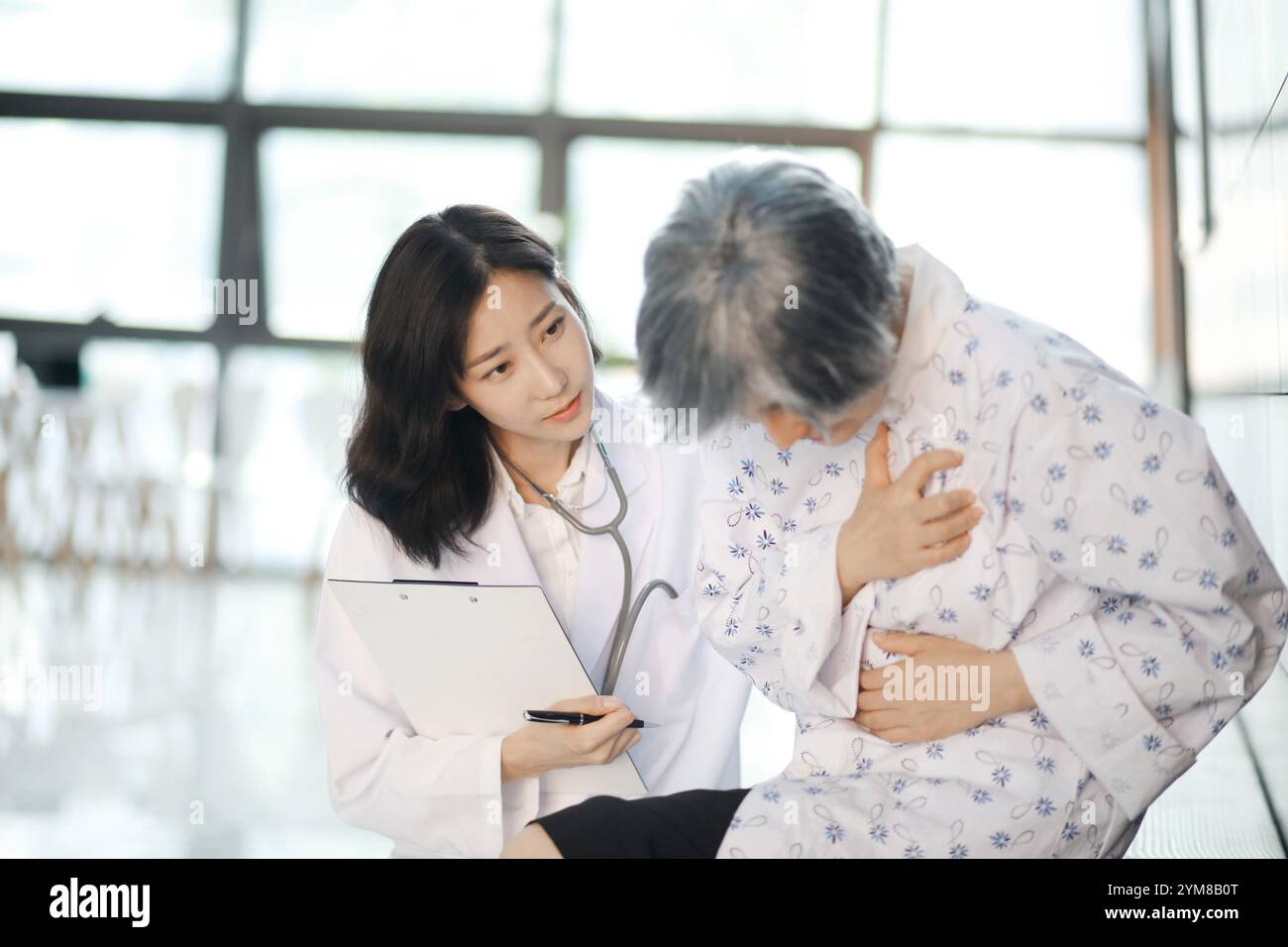 Female doctor checking a patient with chest pain Stock Photo - Alamy