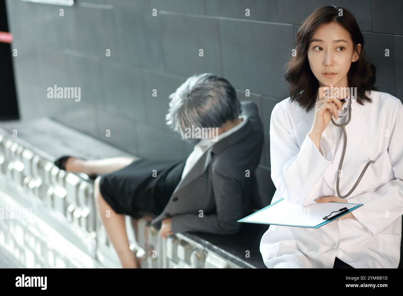 Female doctor and patient holding chart Stock Photo - Alamy