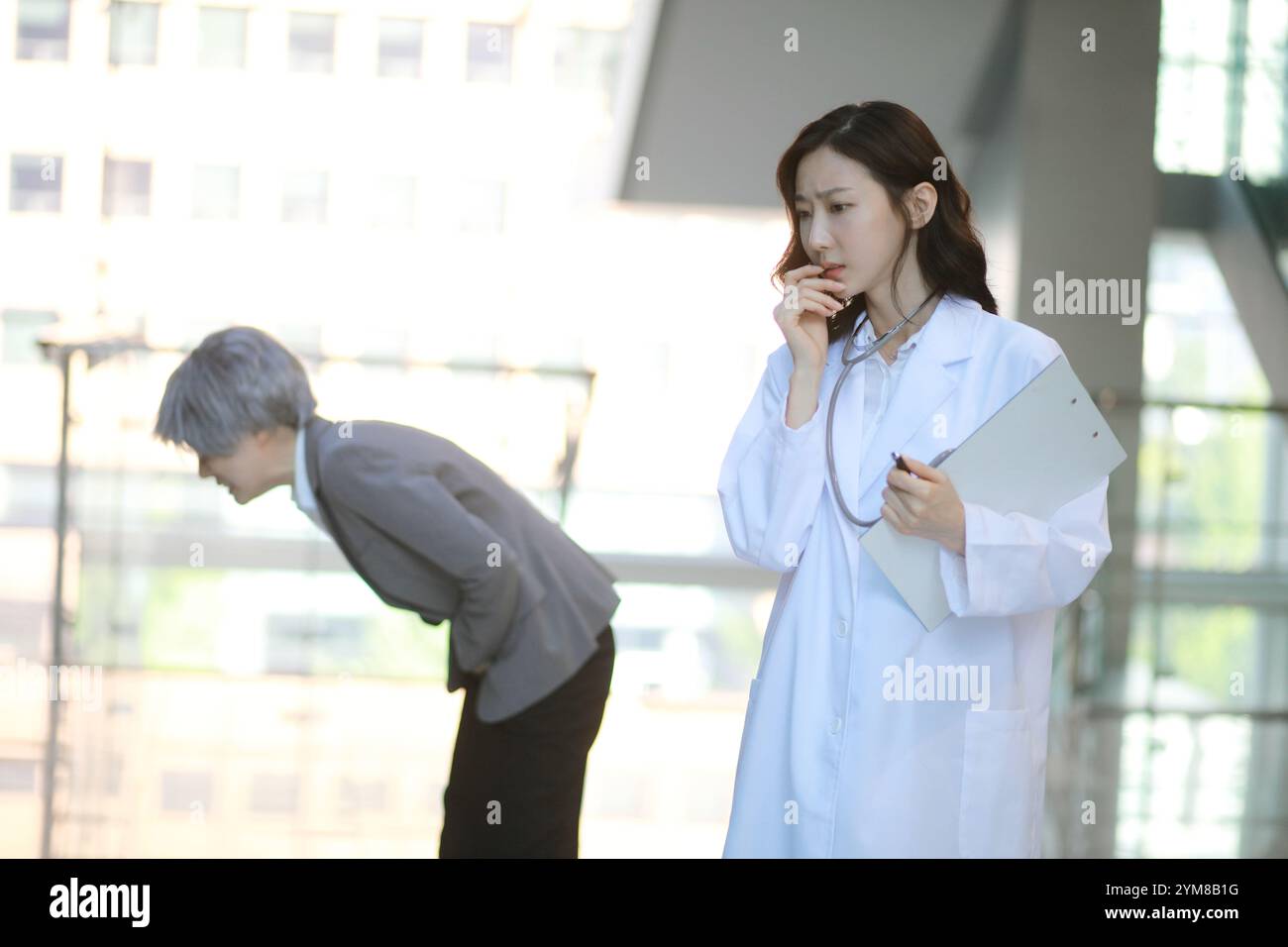 Concerned female doctor and patient Stock Photo - Alamy