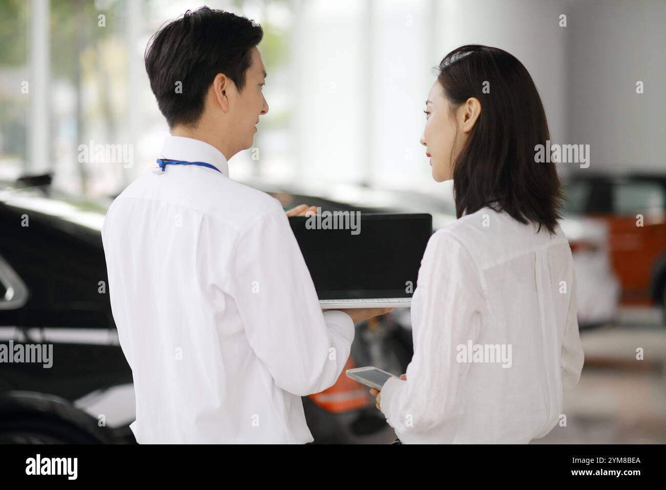 Sales representative selling car sales Stock Photo - Alamy