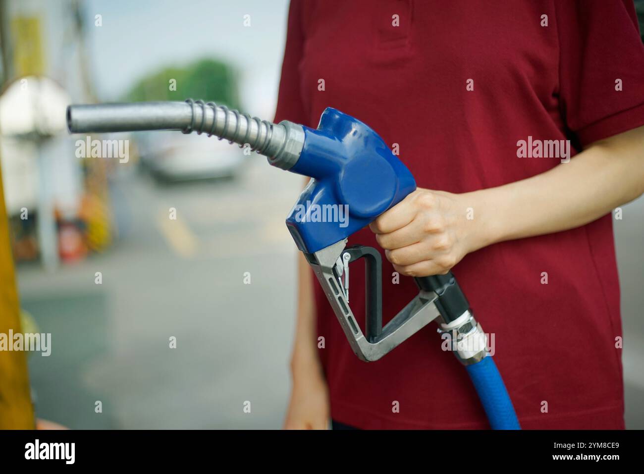 Woman with refuelling machine Stock Photo - Alamy