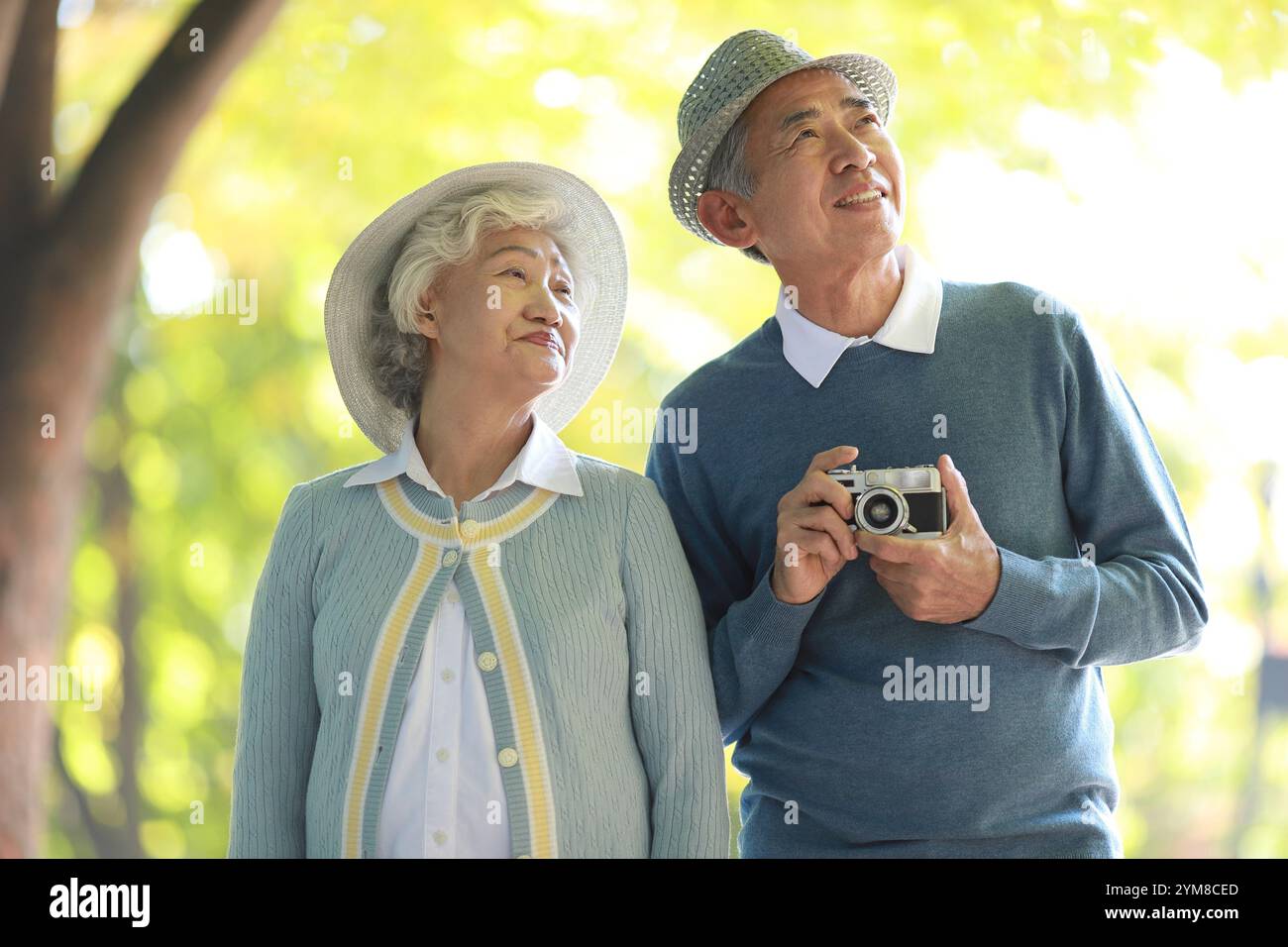 Elderly couple taking a walk in the park Stock Photo - Alamy