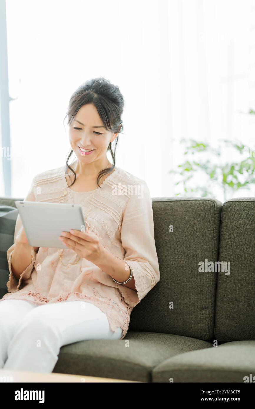 Woman operating tablet pc Stock Photo - Alamy