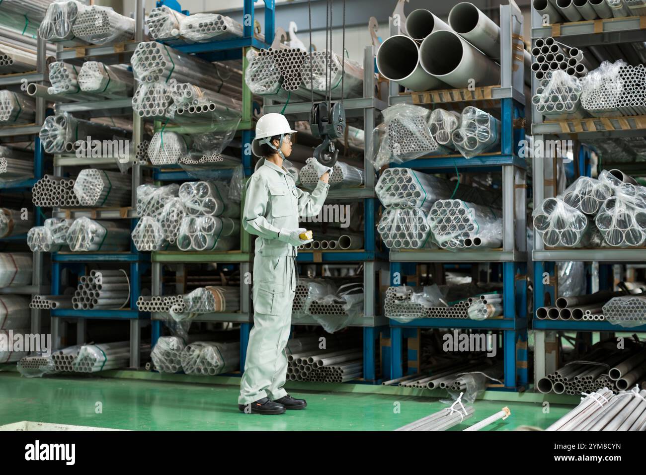 Man in work clothes working in warehouse Stock Photo - Alamy
