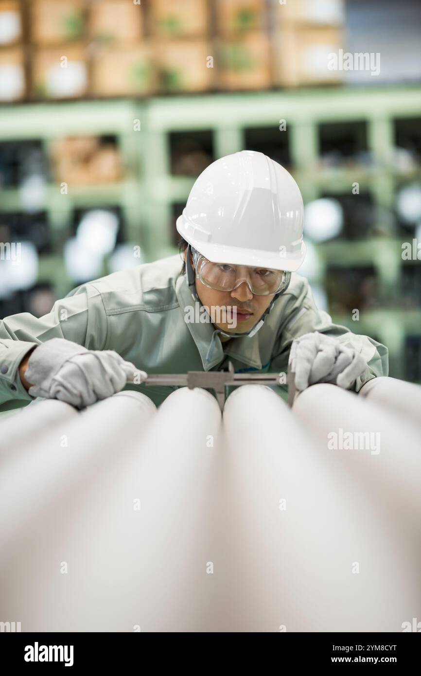 Man in work clothes working in warehouse Stock Photo - Alamy