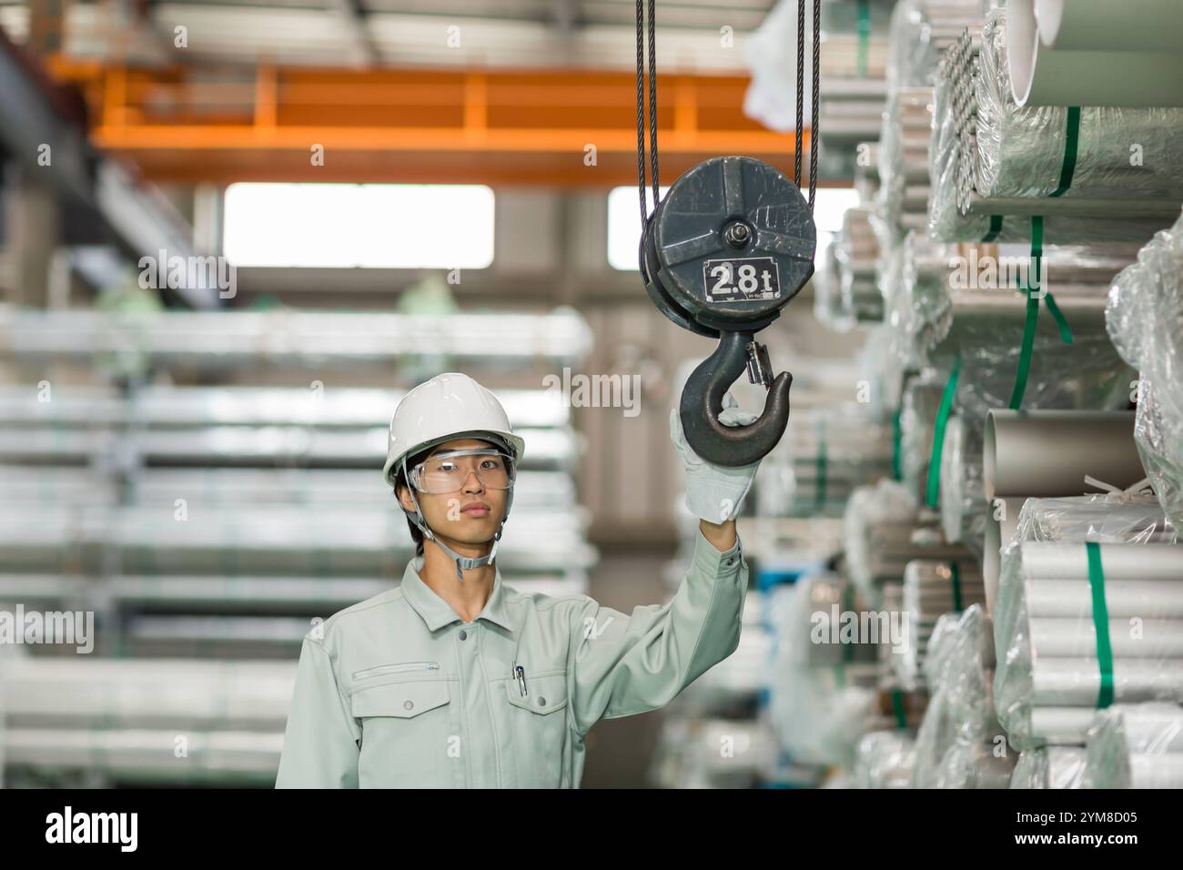 Man in work clothes working in warehouse Stock Photo - Alamy