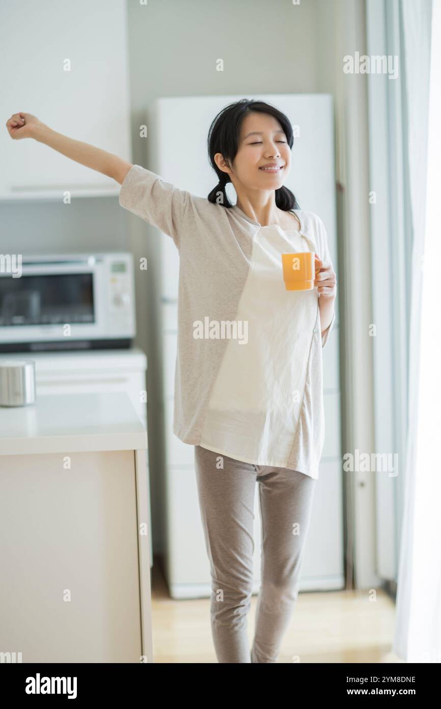 Woman stretching holding cup hi-res stock photography and images - Alamy