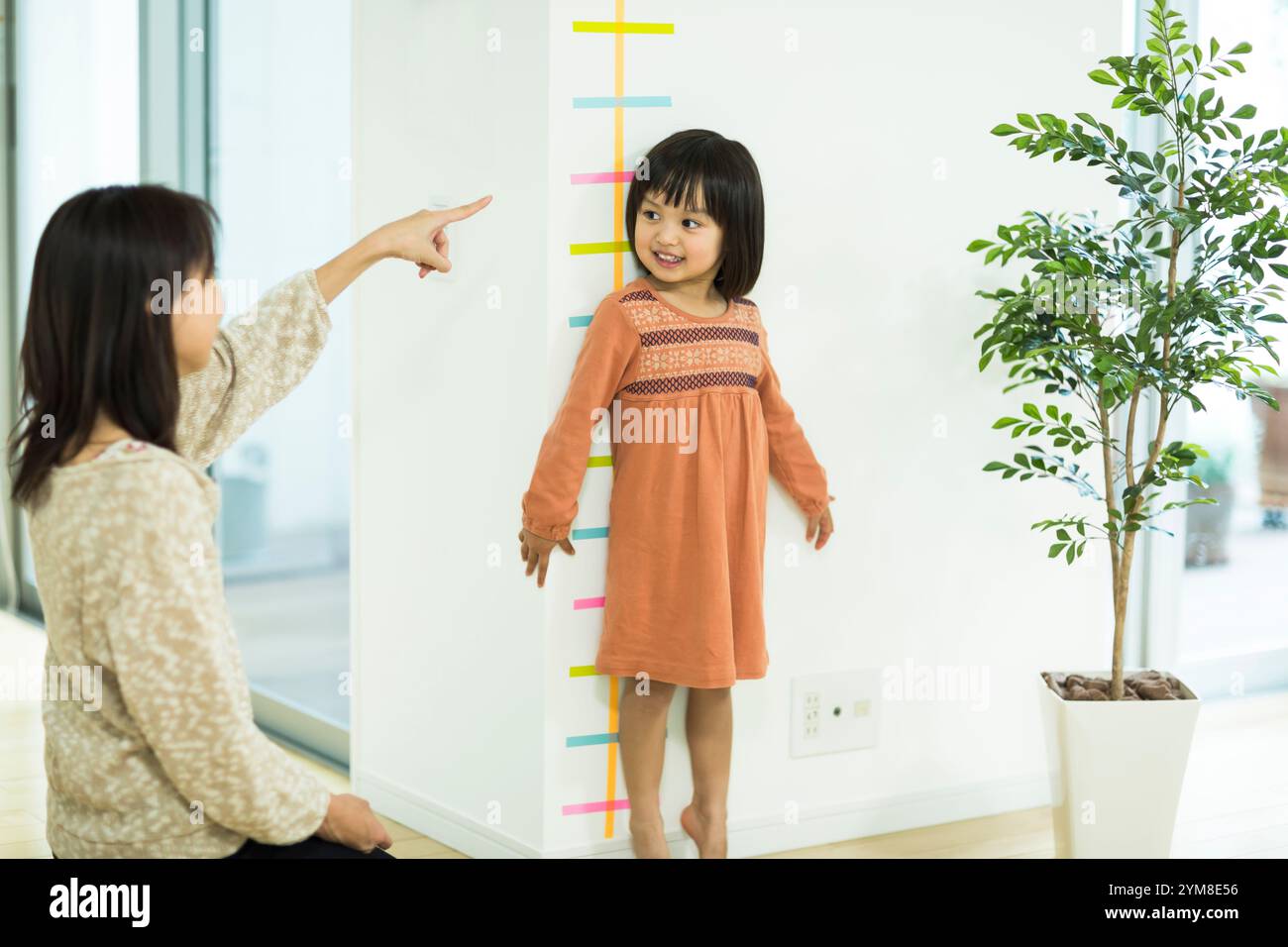 Girl being measured for height Stock Photo - Alamy