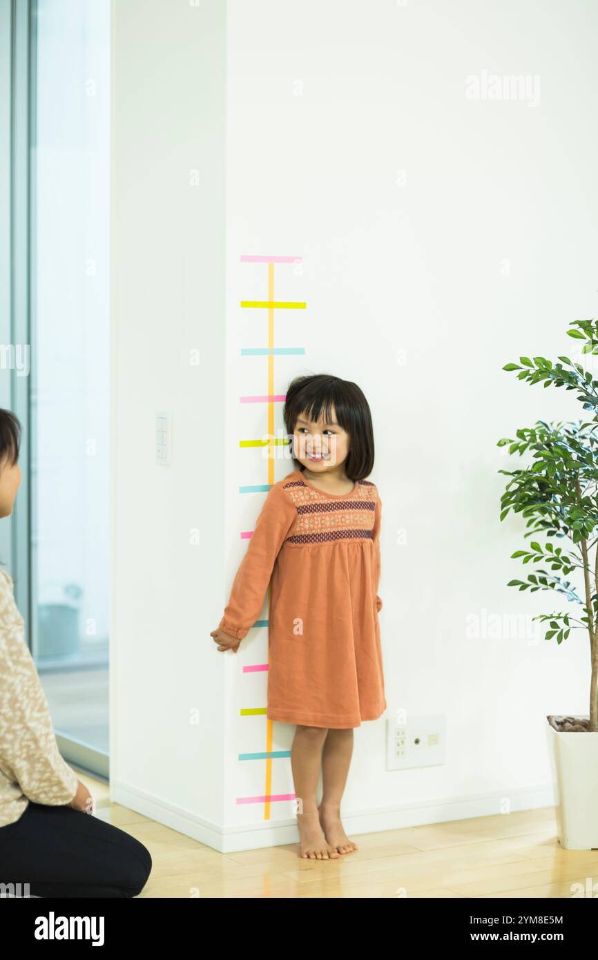 Girl being measured for height Stock Photo - Alamy