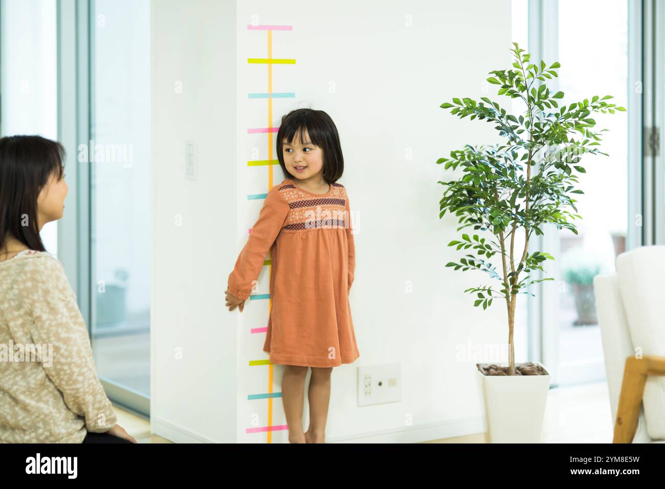 Girl being measured for height Stock Photo - Alamy
