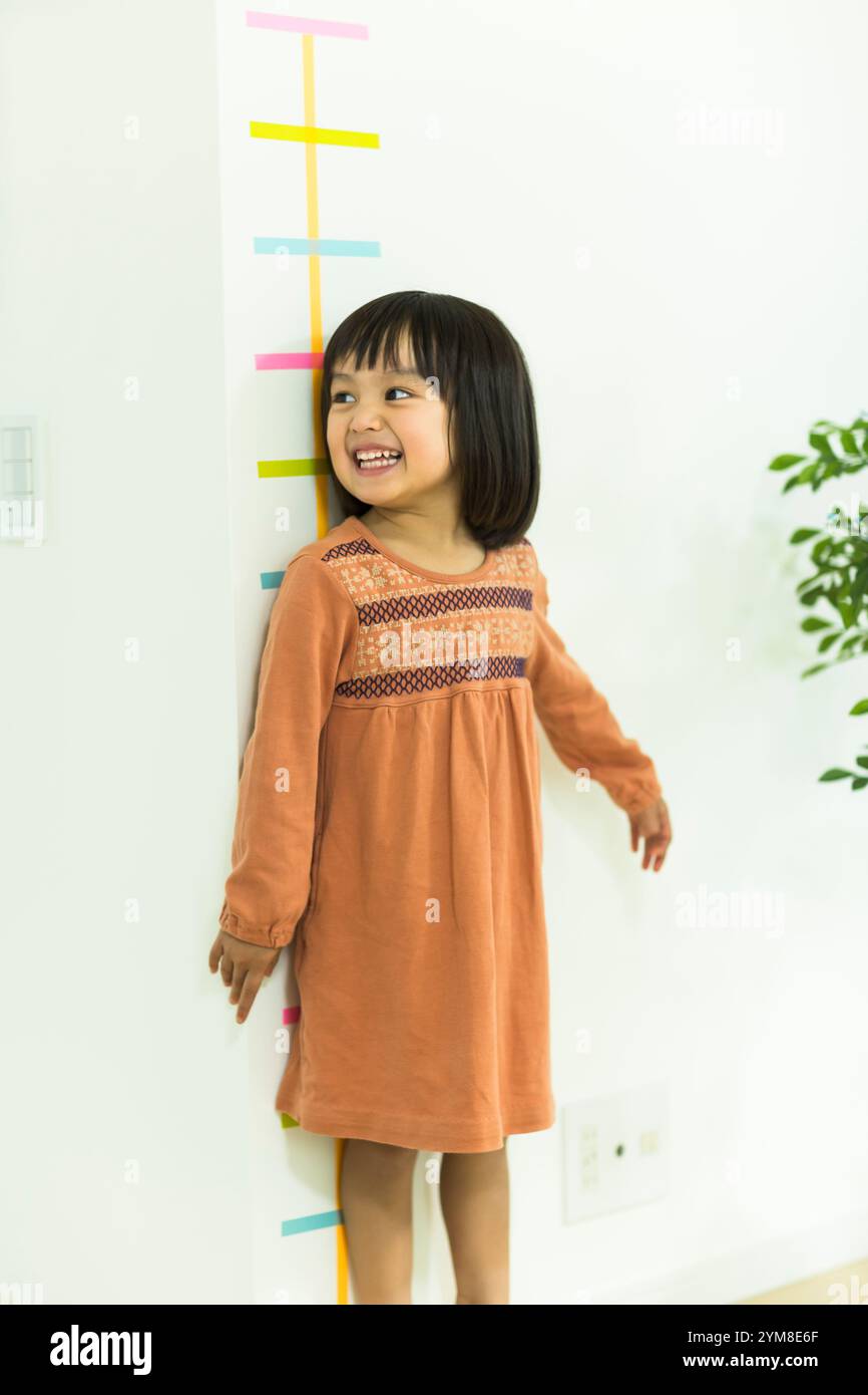 Girl being measured for height Stock Photo - Alamy