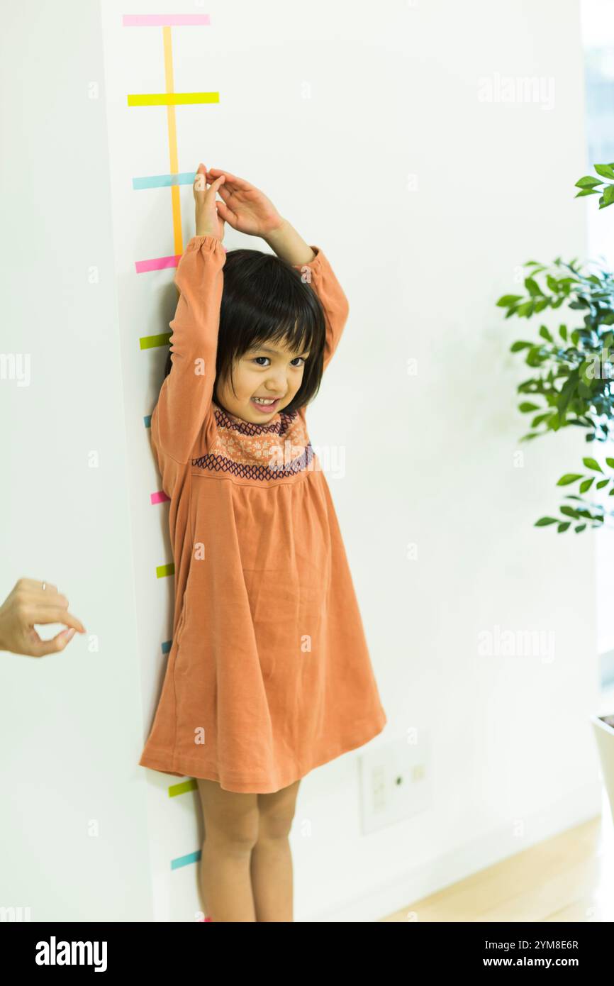 Girl being measured for height Stock Photo - Alamy