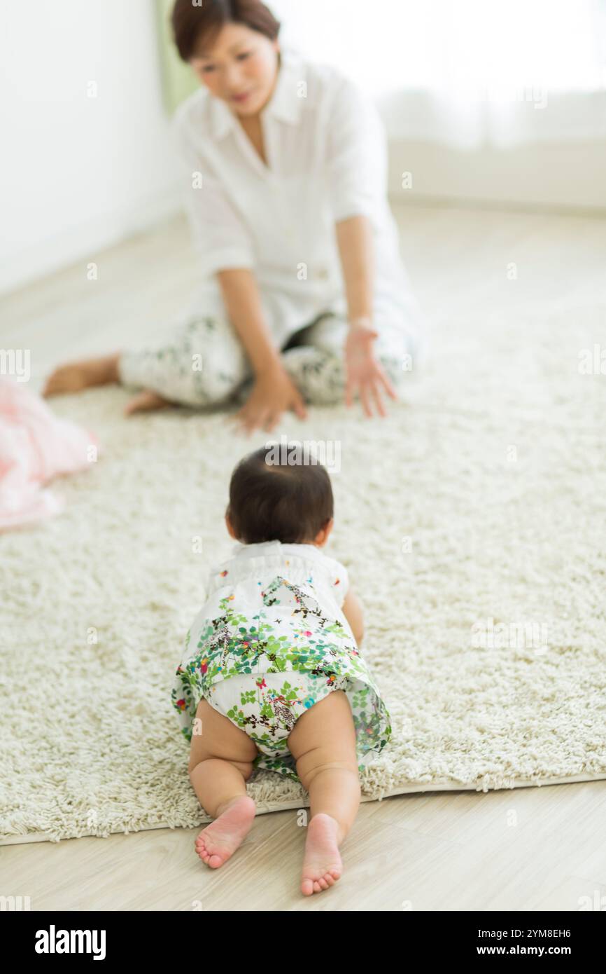 Baby crawling towards mother hi-res stock photography and images - Alamy