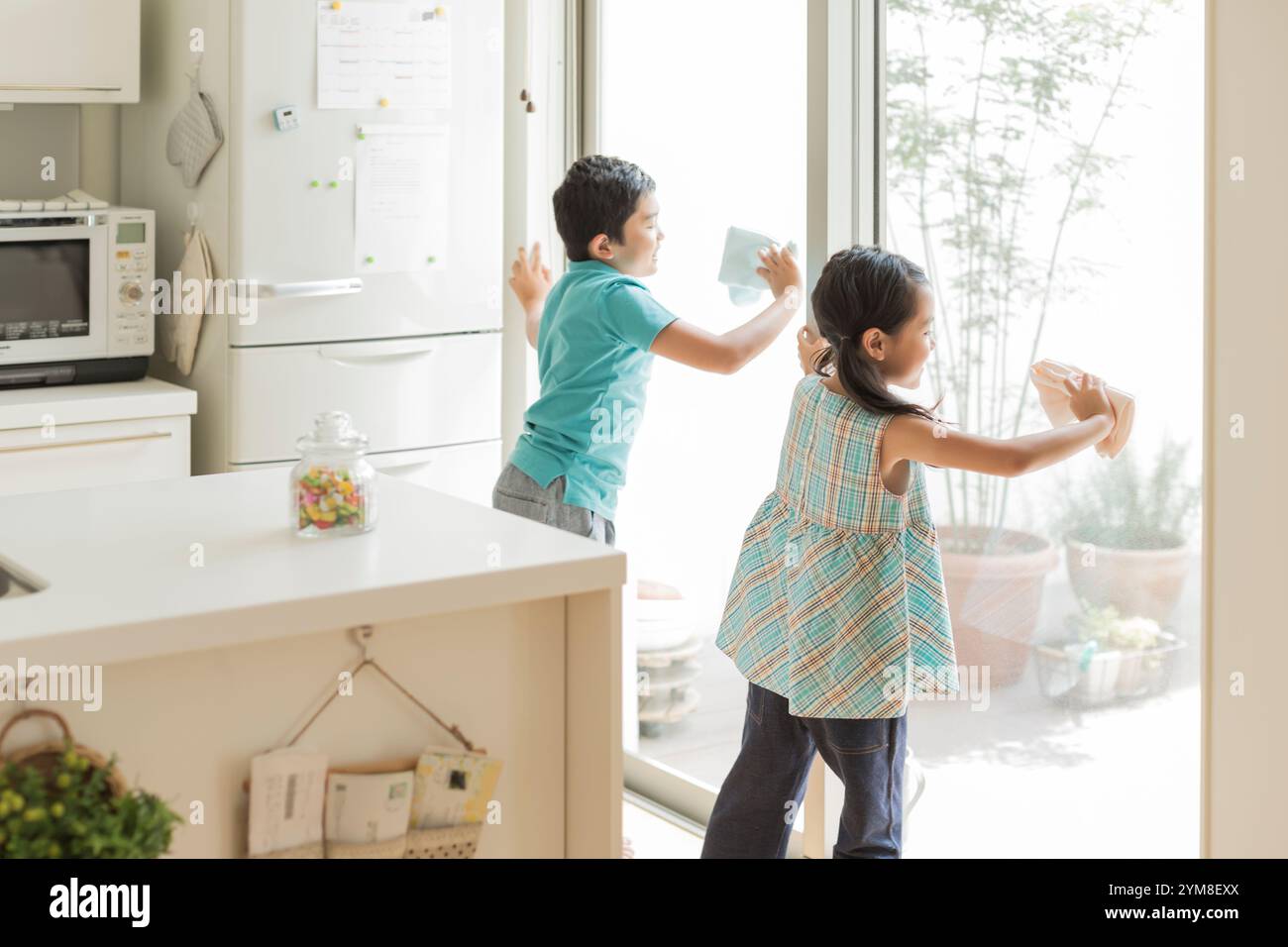 Brother and sister cleaning window Stock Photo - Alamy