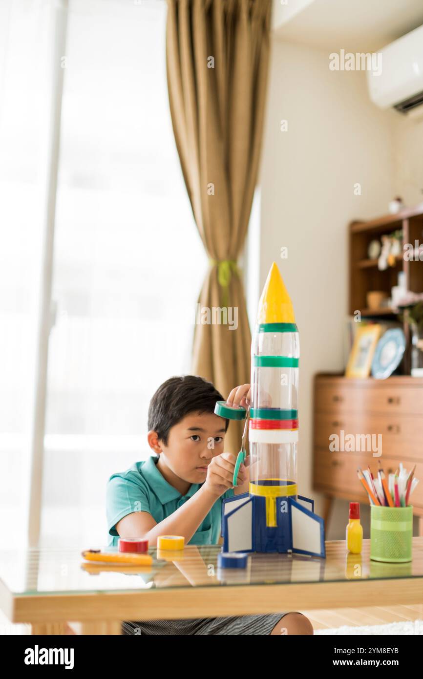 Boy making a rocket out of a plastic bottle Stock Photo - Alamy