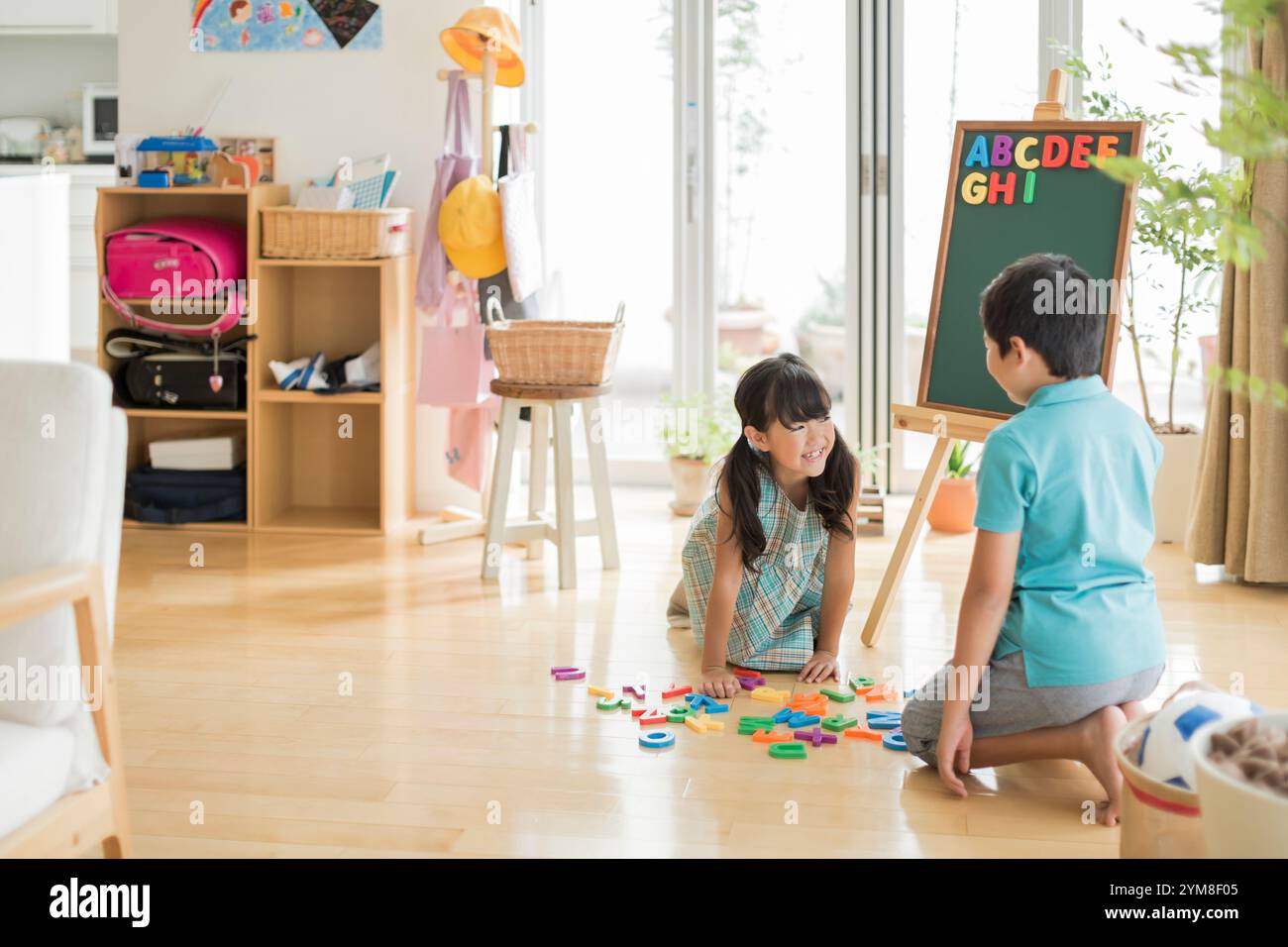 Brother and sister playing with alphabet Stock Photo - Alamy