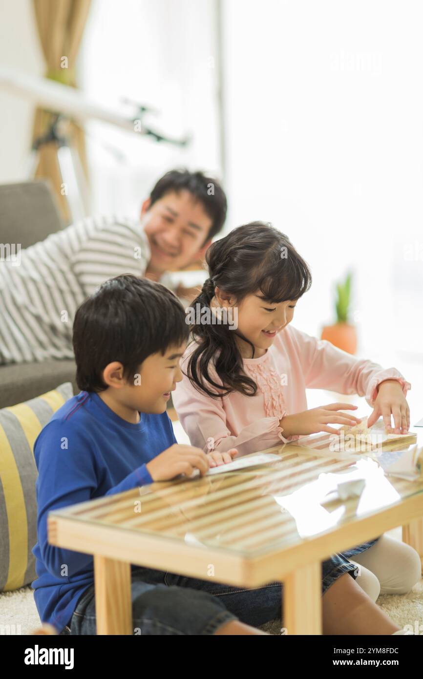 Children playing with Origami Stock Photo - Alamy