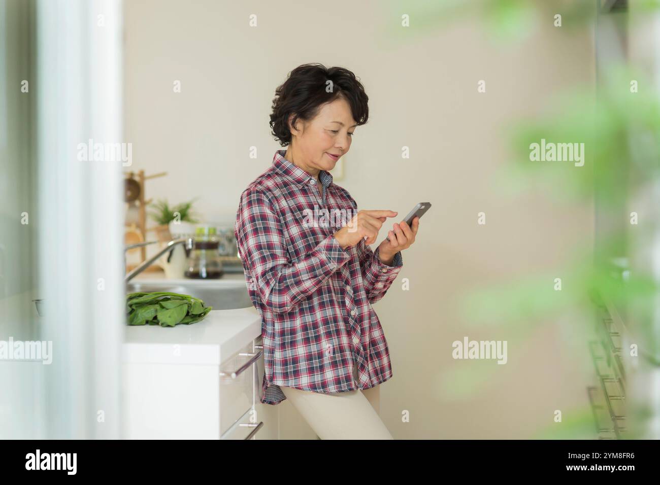 Senior women operating smartphones Stock Photo - Alamy