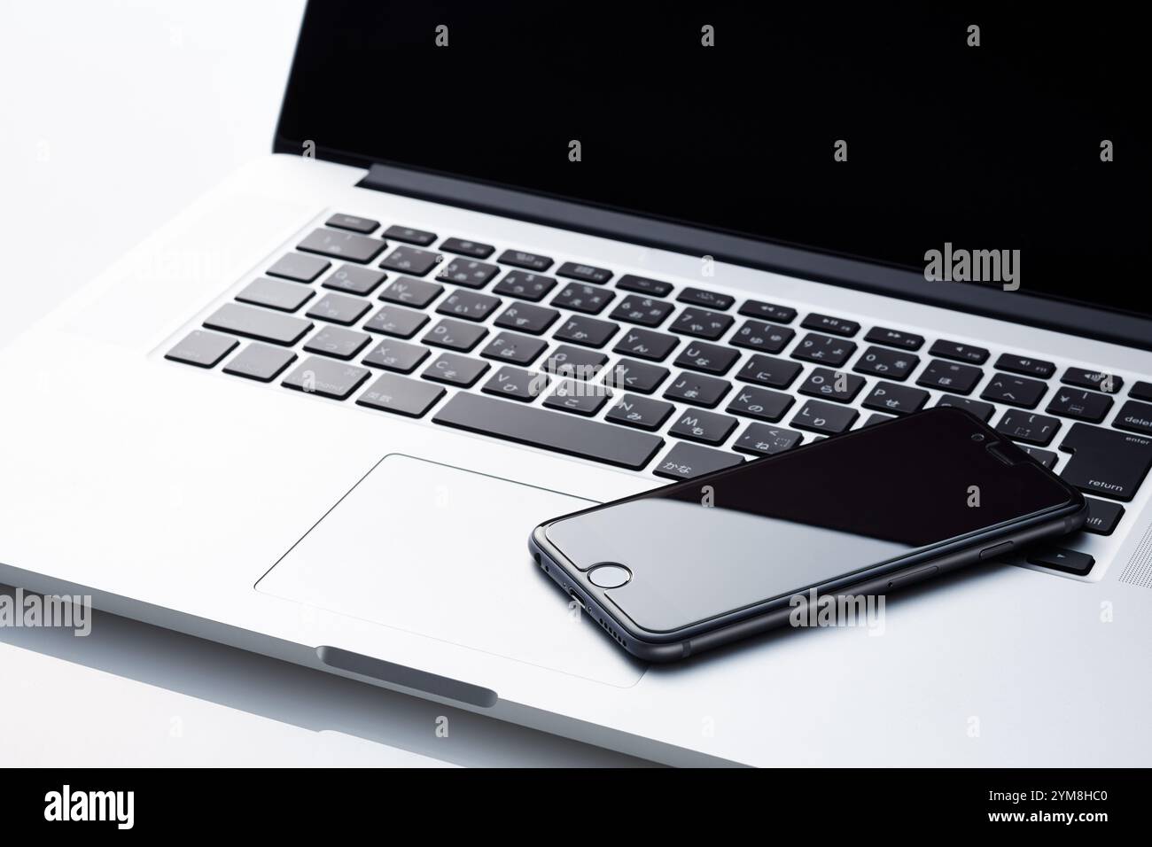 Smartphone on top of a computer Stock Photo - Alamy