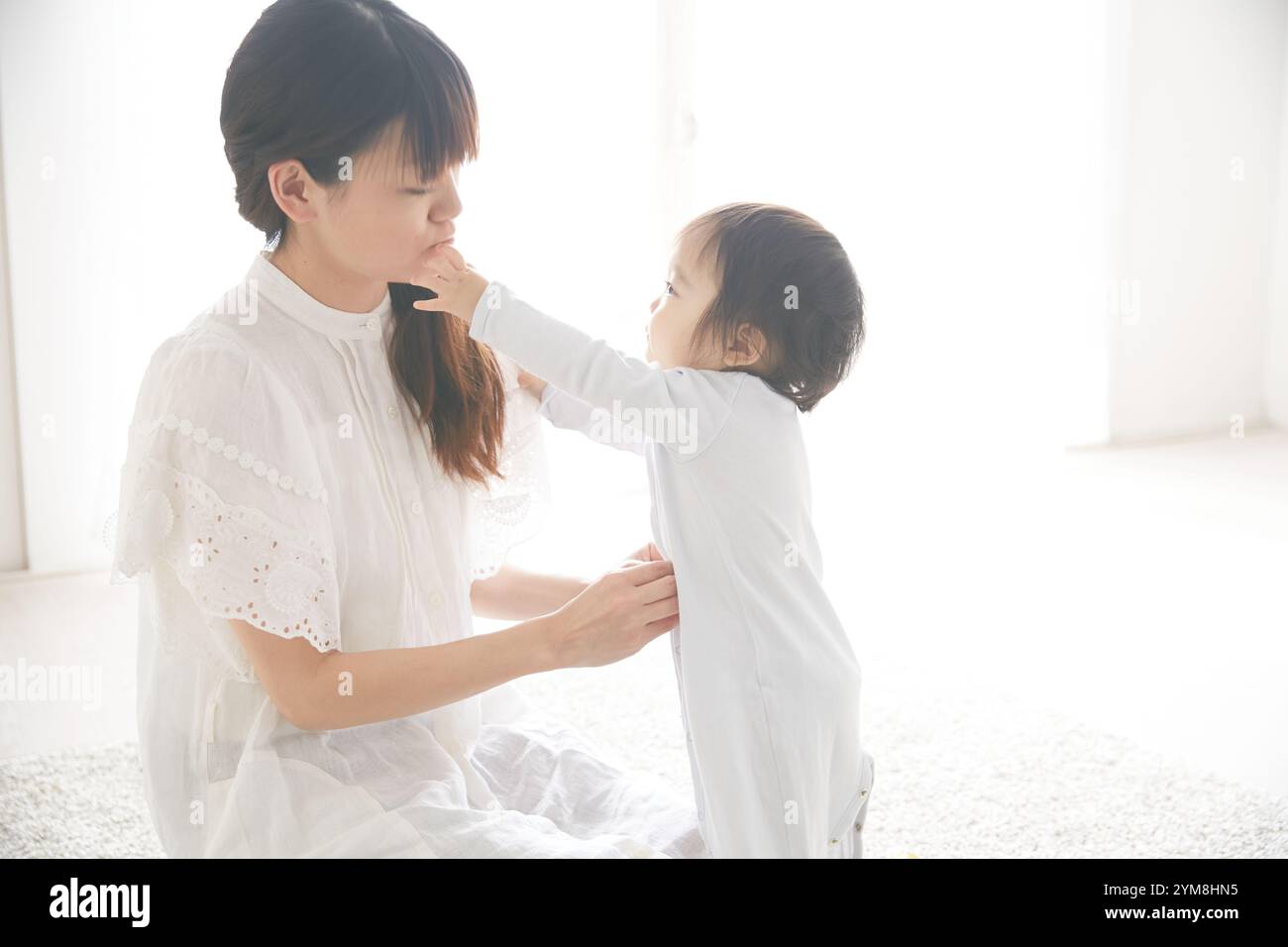 Baby getting dressed Stock Photo - Alamy