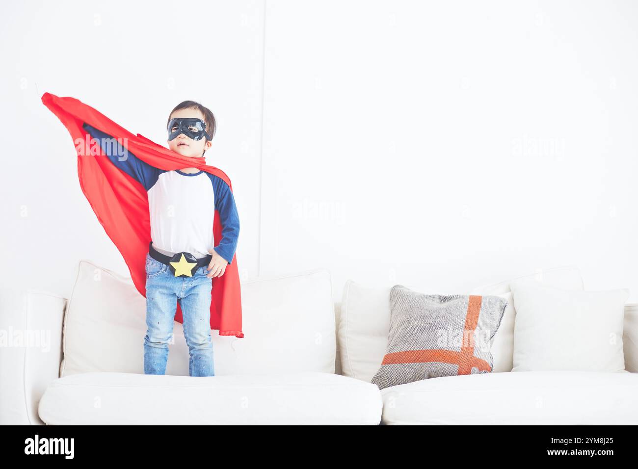 A happy child playing Superman Stock Photo - Alamy