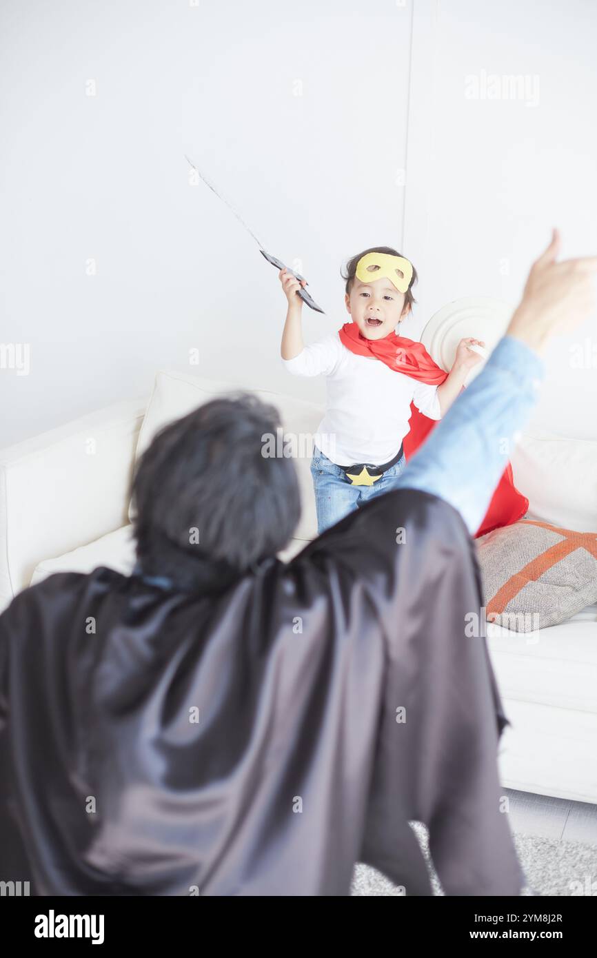 Little Superman fighting with his dad Stock Photo - Alamy