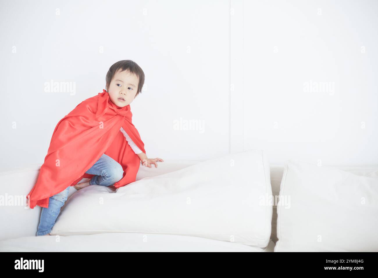 Boy playing with cape Stock Photo - Alamy