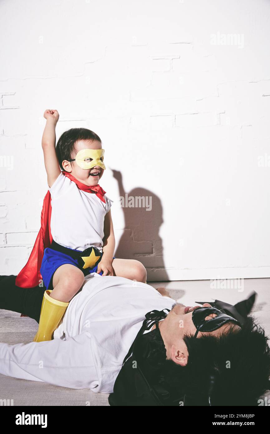 Hero boy fighting off bad guys Stock Photo - Alamy
