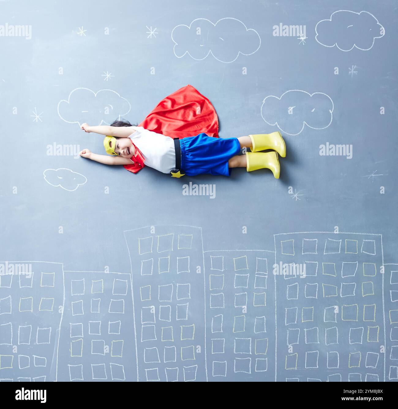 Hero boy flying in the sky in a graffiti world Stock Photo - Alamy