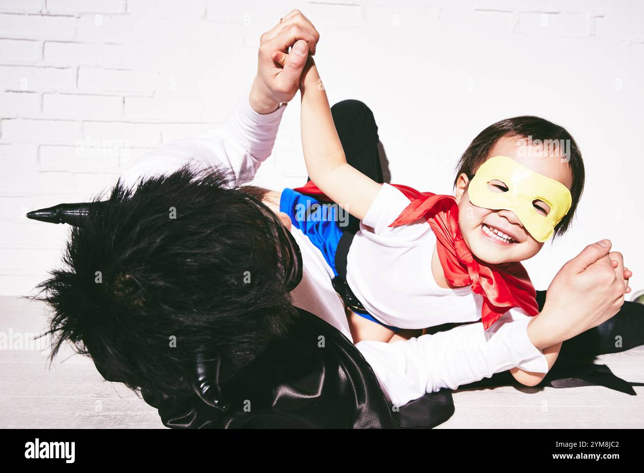 Hero boy fighting off bad guys Stock Photo - Alamy