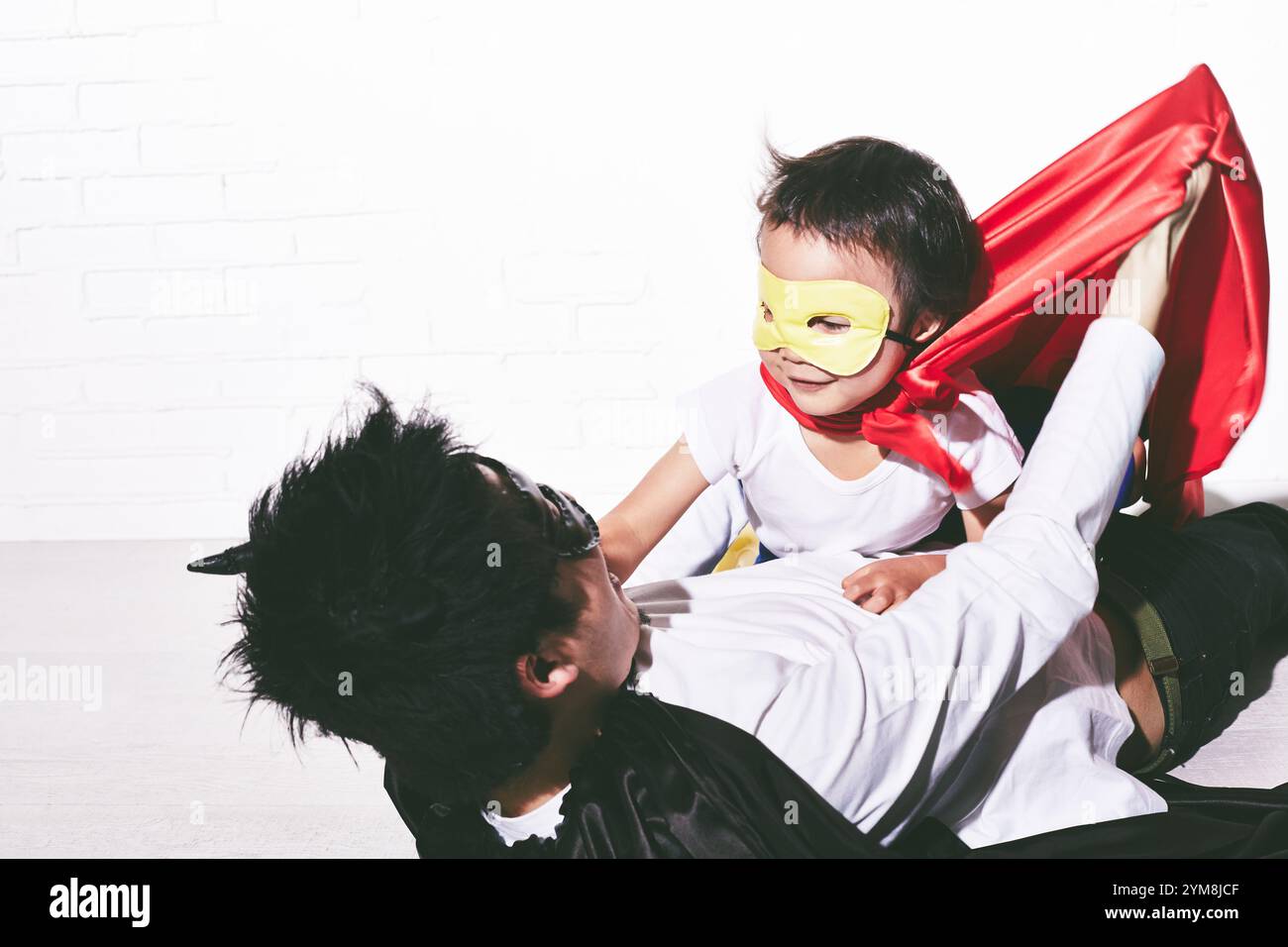 Hero boy fighting off bad guys Stock Photo - Alamy