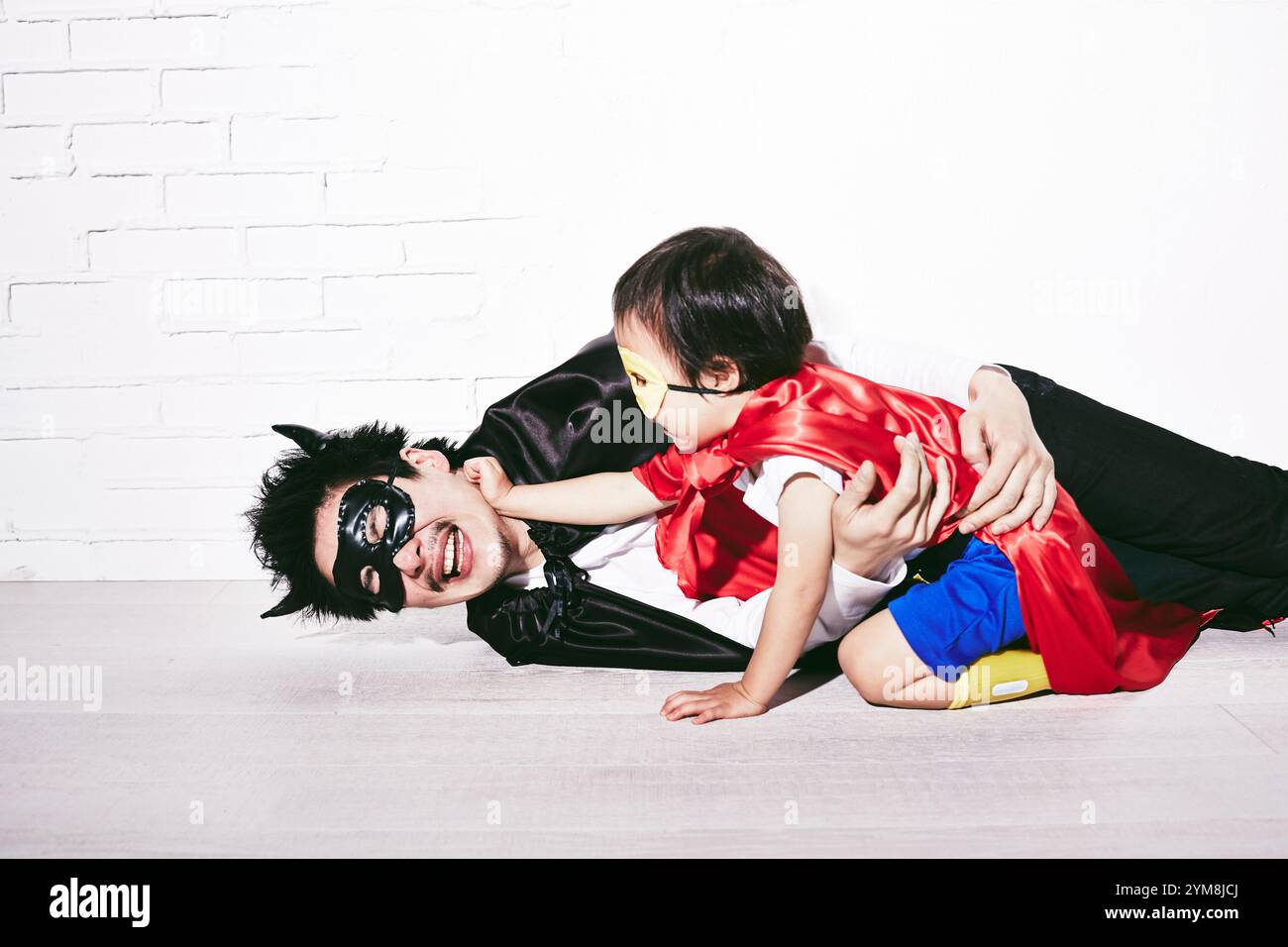 Hero boy fighting off bad guys Stock Photo - Alamy