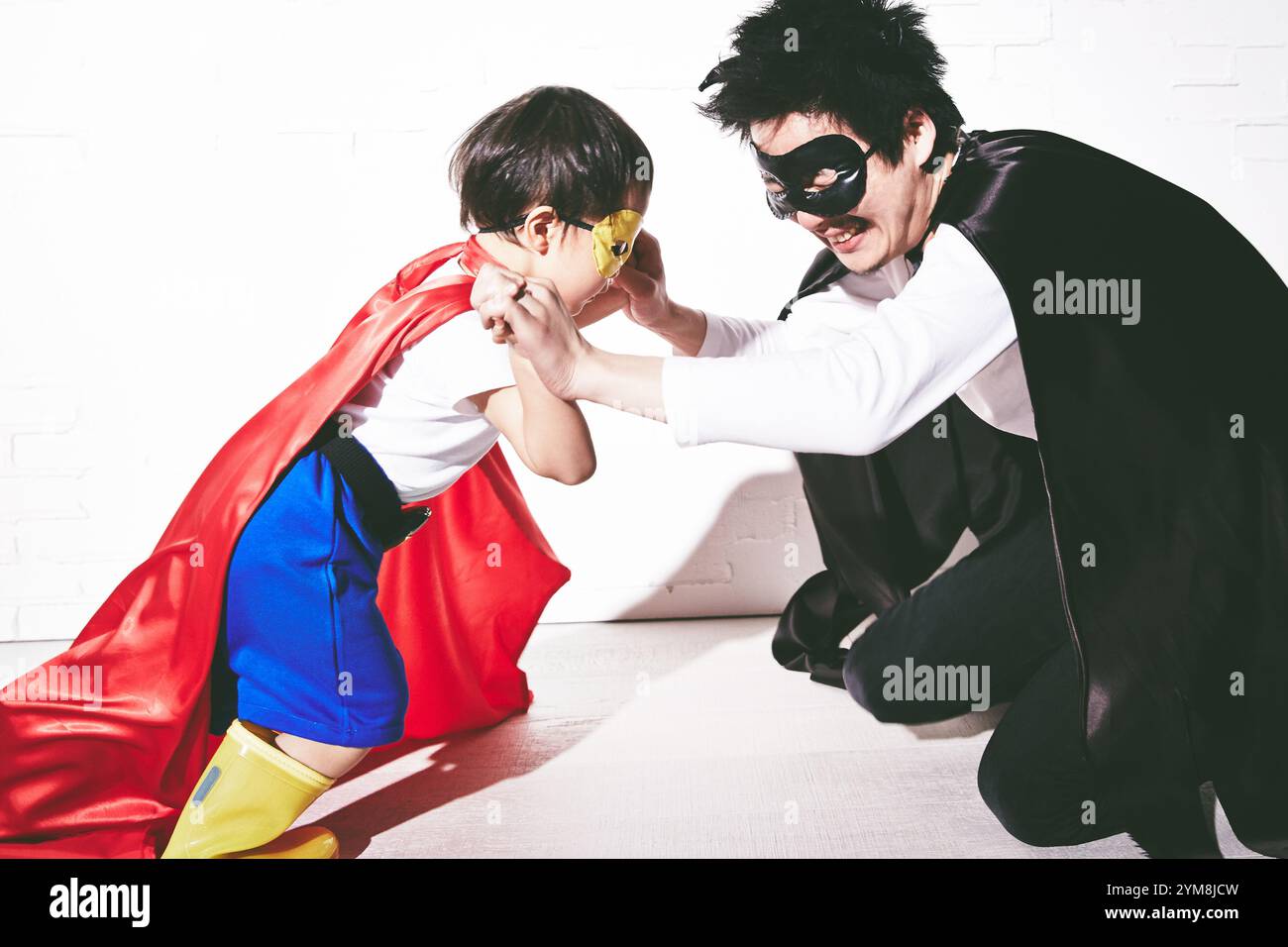 Hero boy fighting off bad guys Stock Photo - Alamy