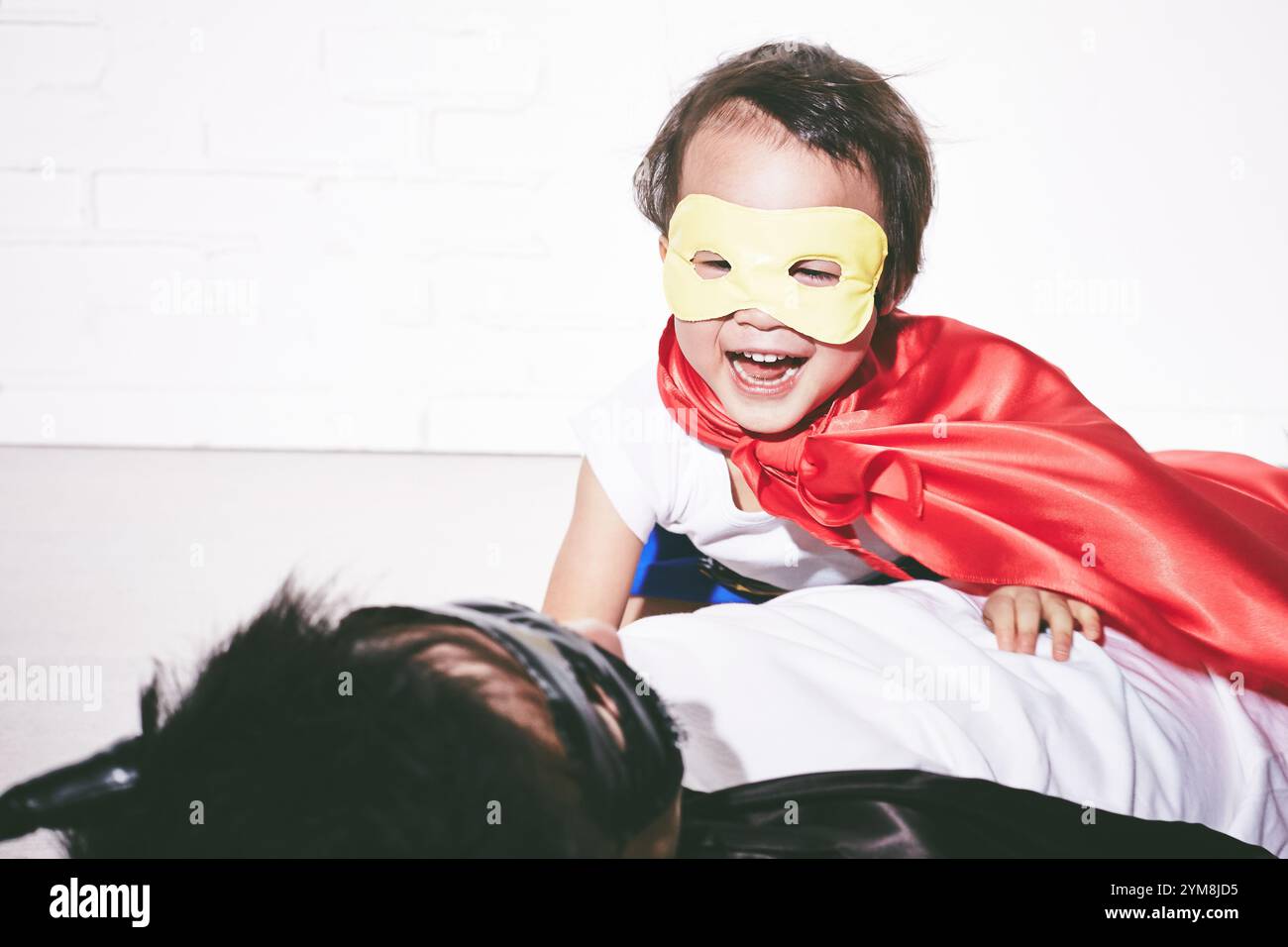 Hero boy fighting off bad guys Stock Photo - Alamy