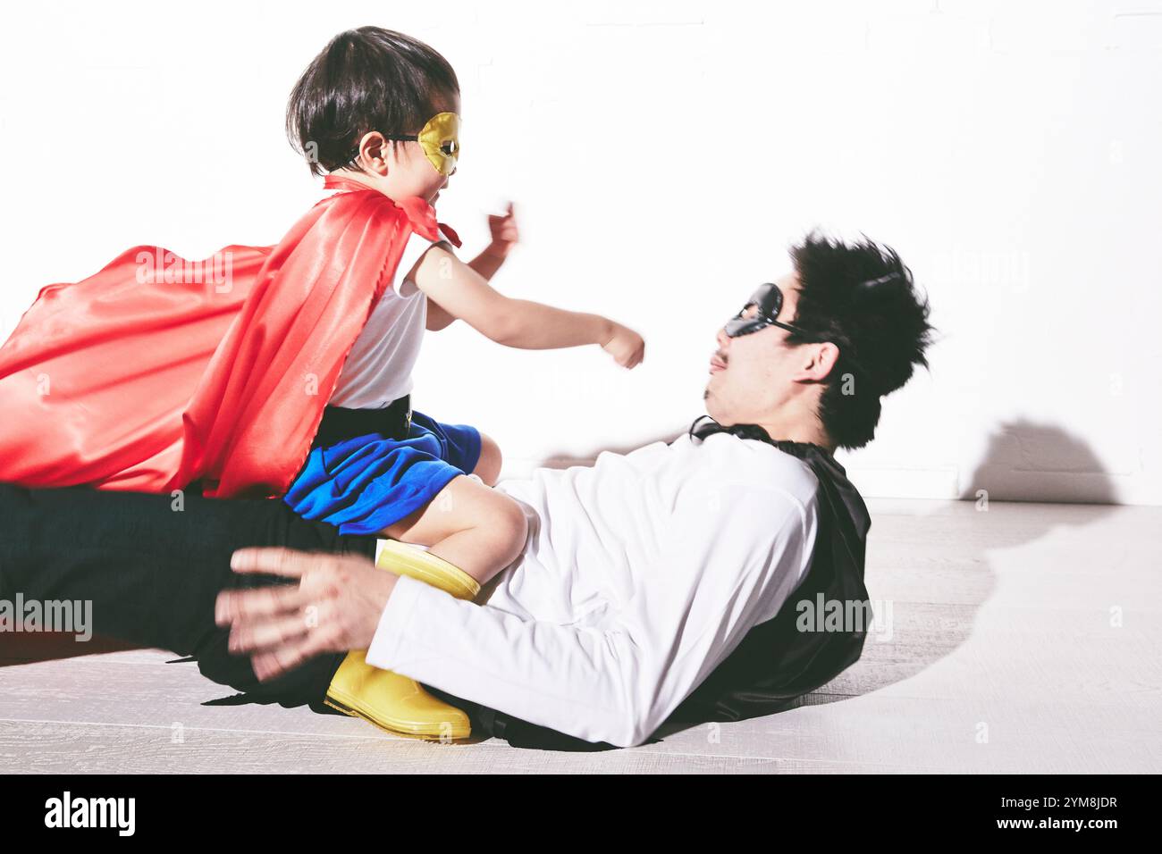 Hero boy fighting off bad guys Stock Photo - Alamy