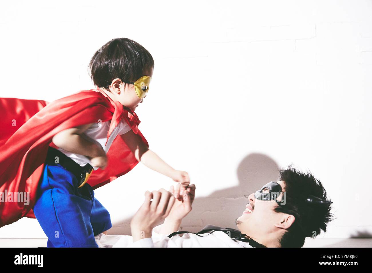 Hero boy fighting off bad guys Stock Photo - Alamy