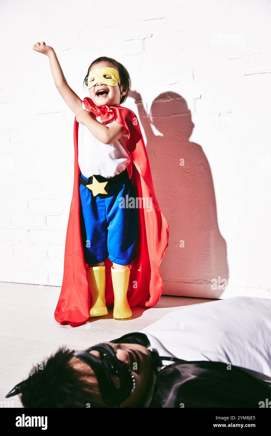 Hero boy striking a pose of victory after defeating the bad guys Stock ...