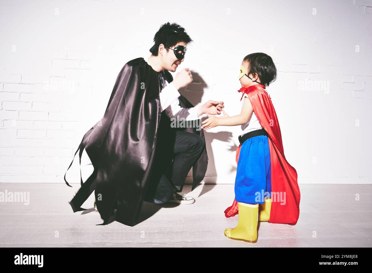 Hero boy fighting off bad guys Stock Photo - Alamy