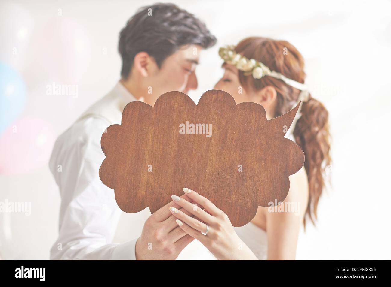 Happy bride and groom with blow-up Stock Photo - Alamy