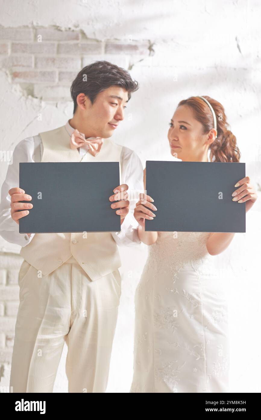 Happy bride and groom with blow-up Stock Photo - Alamy
