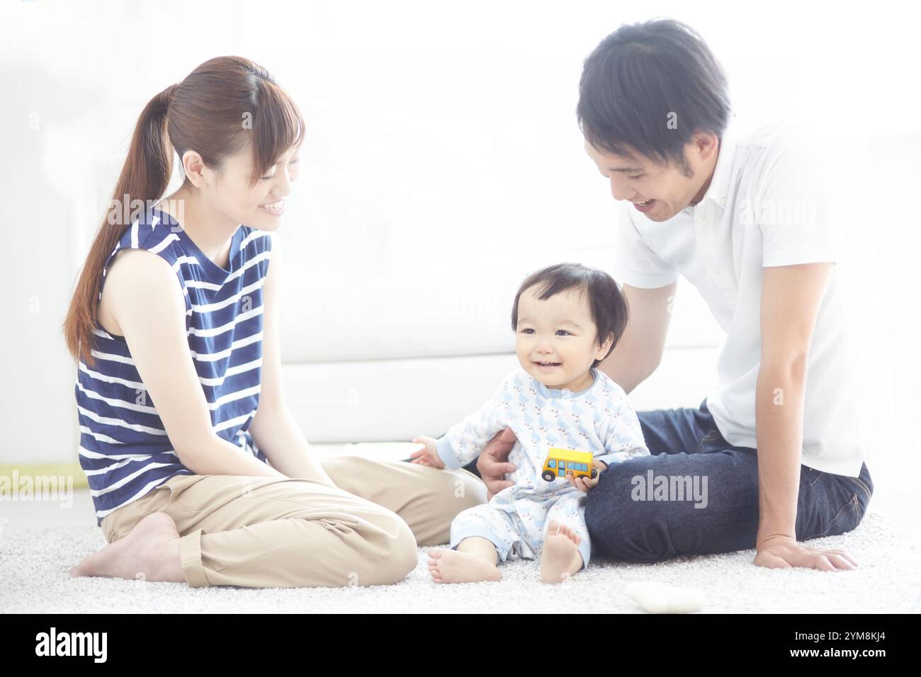 Three family members playing together in a group Stock Photo - Alamy