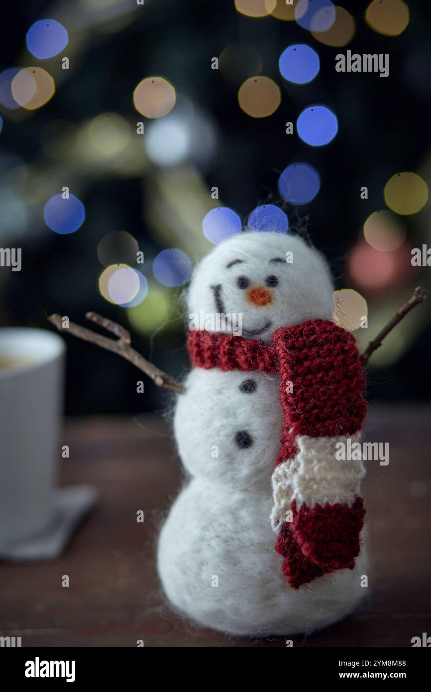Snowman on desk in front of Christmas tree Stock Photo - Alamy