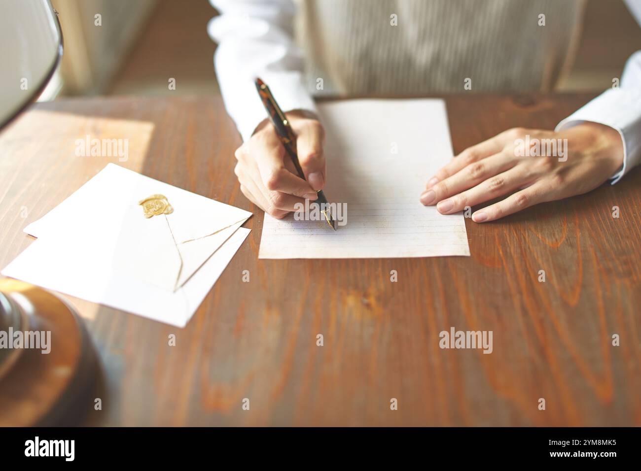 Woman writing letter with envelope hi-res stock photography and images ...